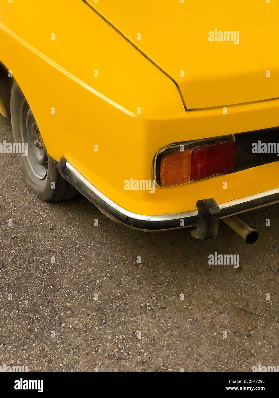 Detail from the back of a vintage yellow car Stock Photo - Alamy
