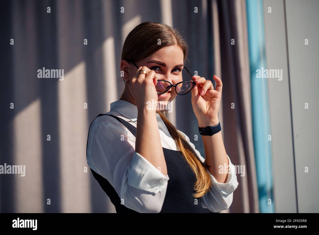Confident business woman boss standing in modern office wearing glasses ...