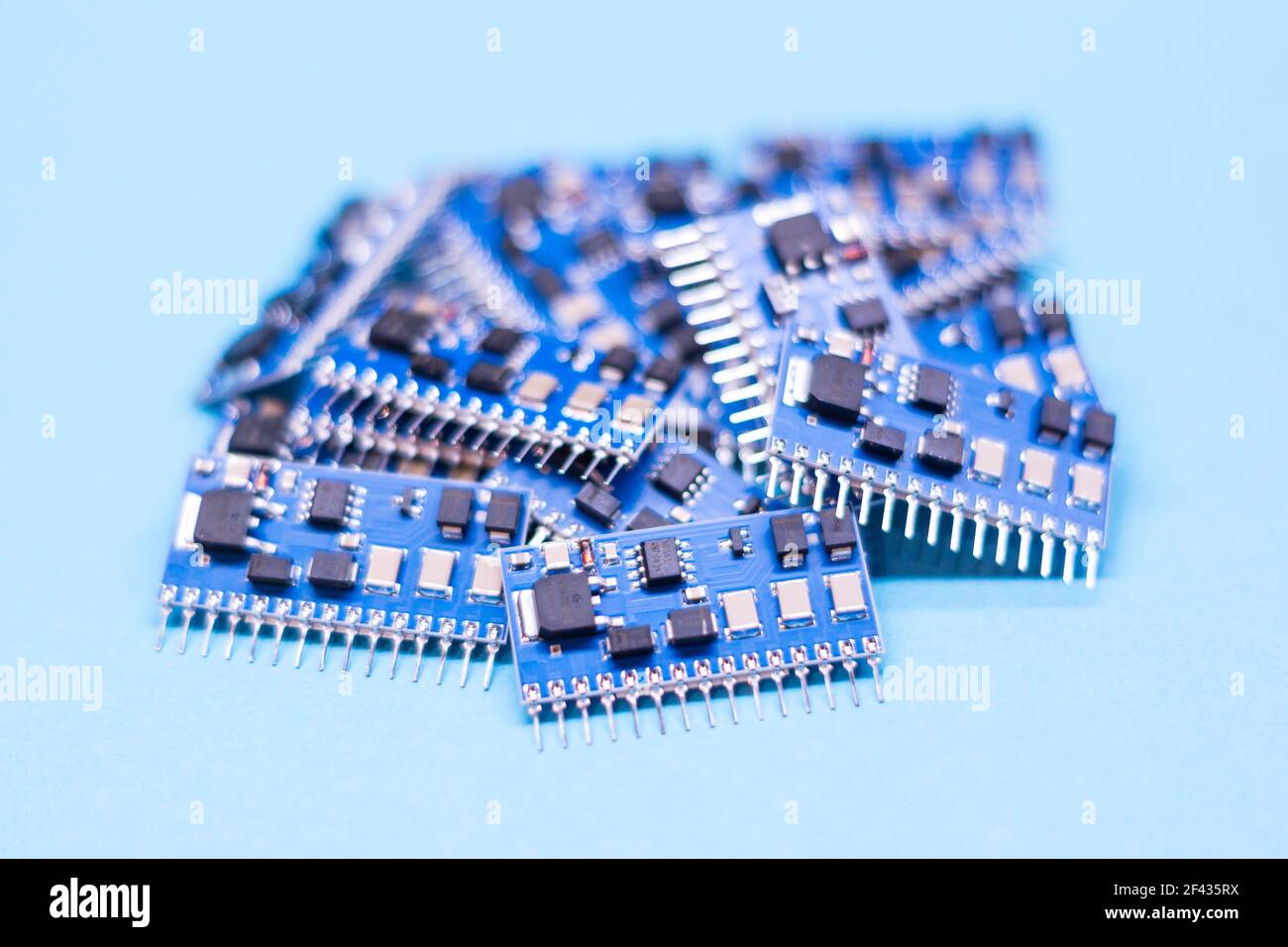 lots of electronic hybrid circuits with blue background Stock Photo - Alamy