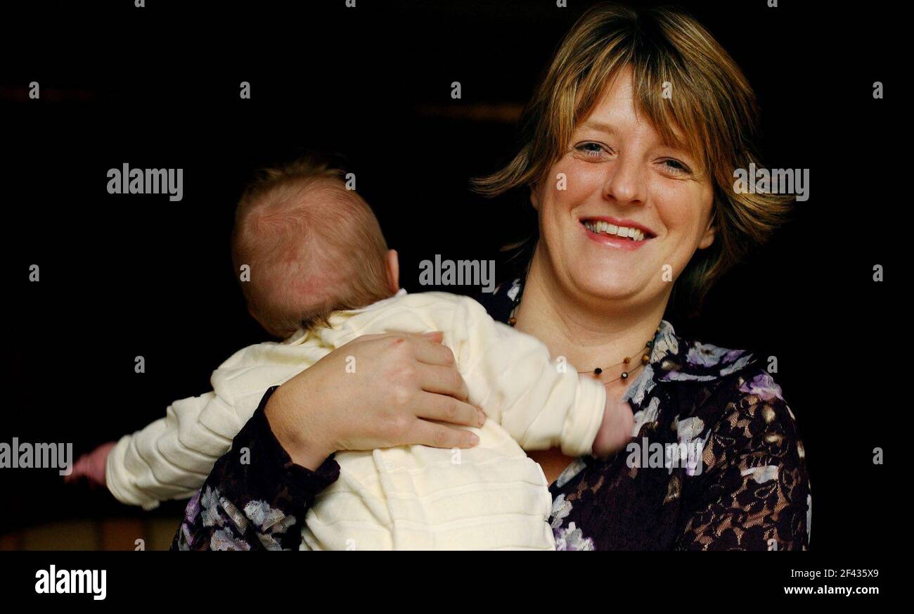 Nanny Jane Austen with a baby at her home in Islington.21 November 2002 ...