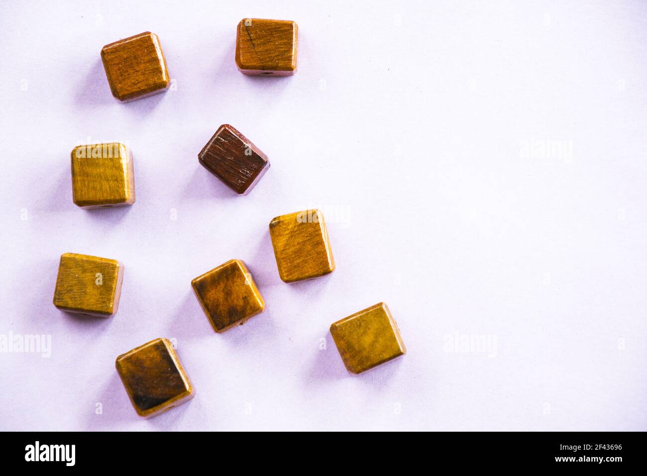 A top view of wooden puzzle cubes in the light background with copy ...