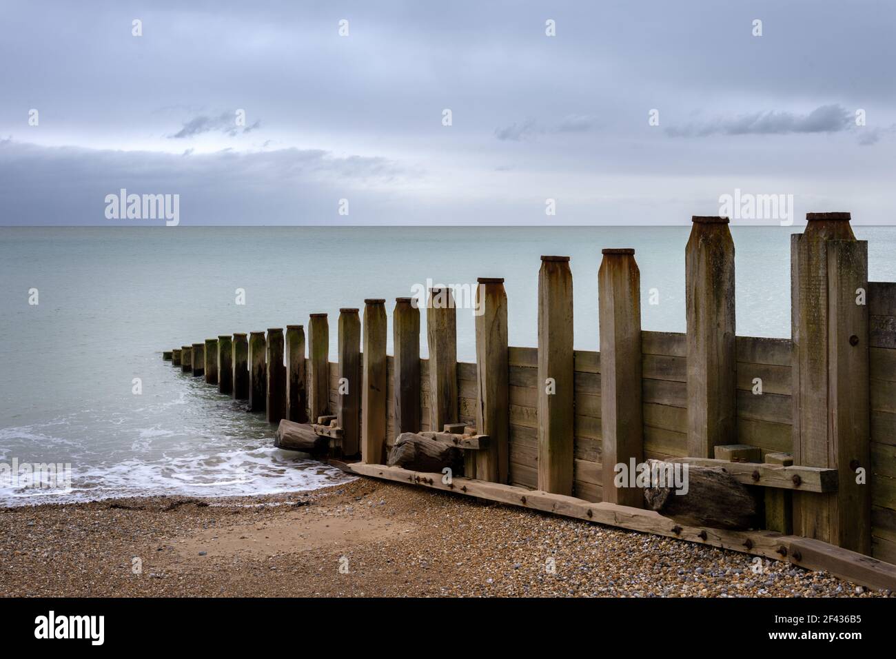 Wooden groynes on Eastbourne beach in Sussex, England, on a cloudy ...