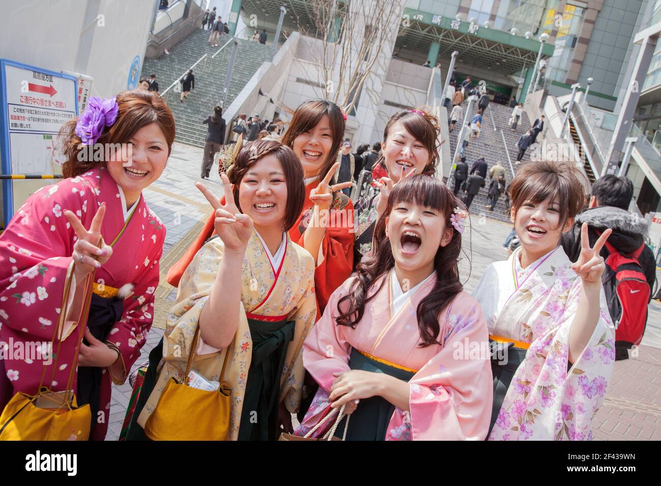 Group of young Japanese females pose for photo wearing kimonos outside ...
