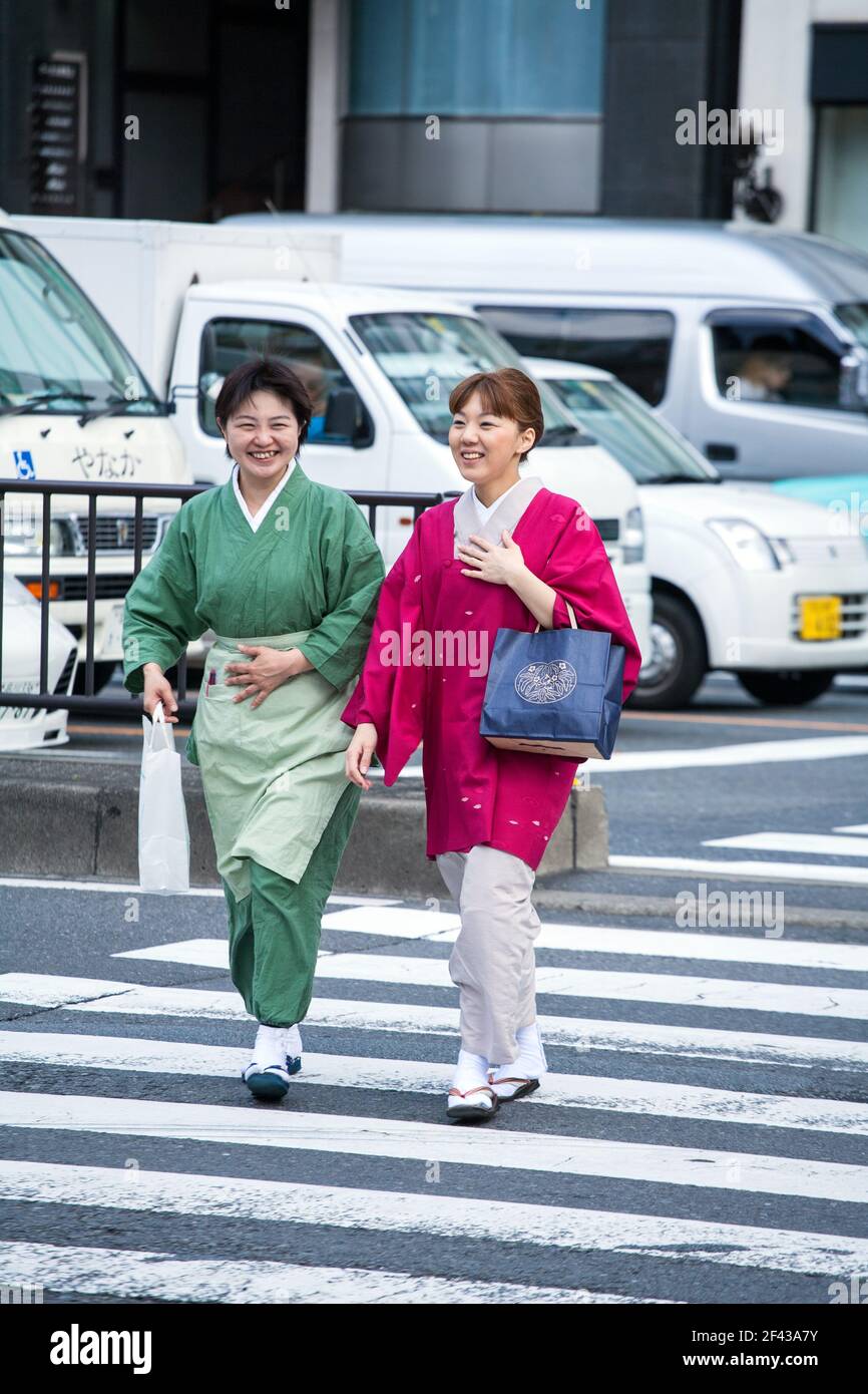 Two Japanese females walking across zebra pedestrian crossing, Aoyama ...