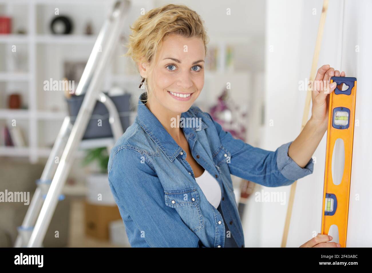 woman using leveling tool at home Stock Photo - Alamy