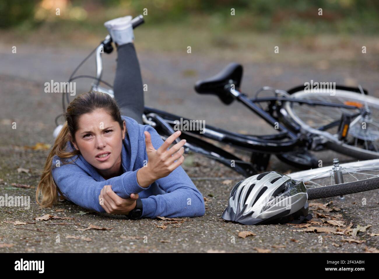young woman fell off her bike Stock Photo - Alamy