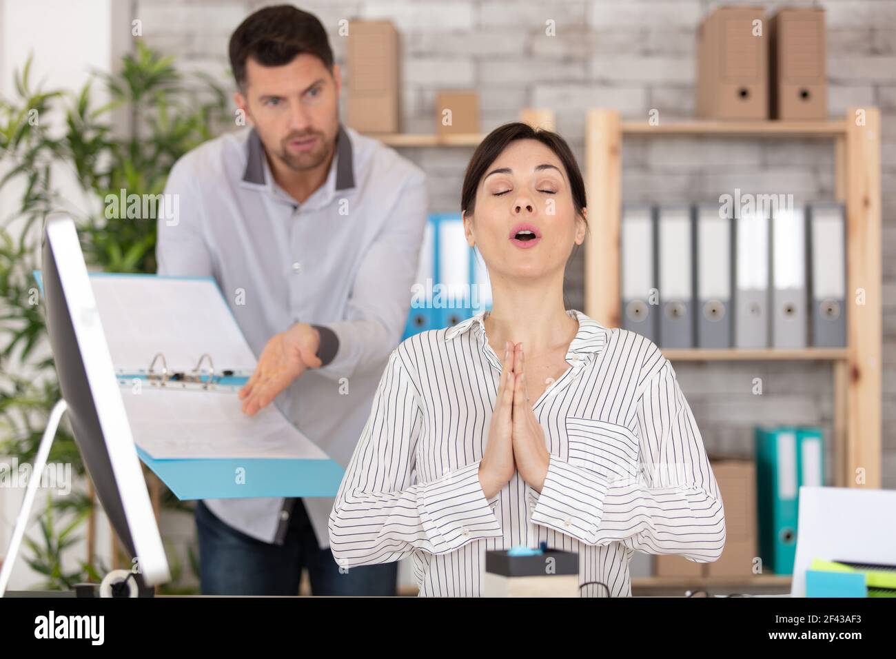 woman remaining zen despite the pressure of the office Stock Photo - Alamy