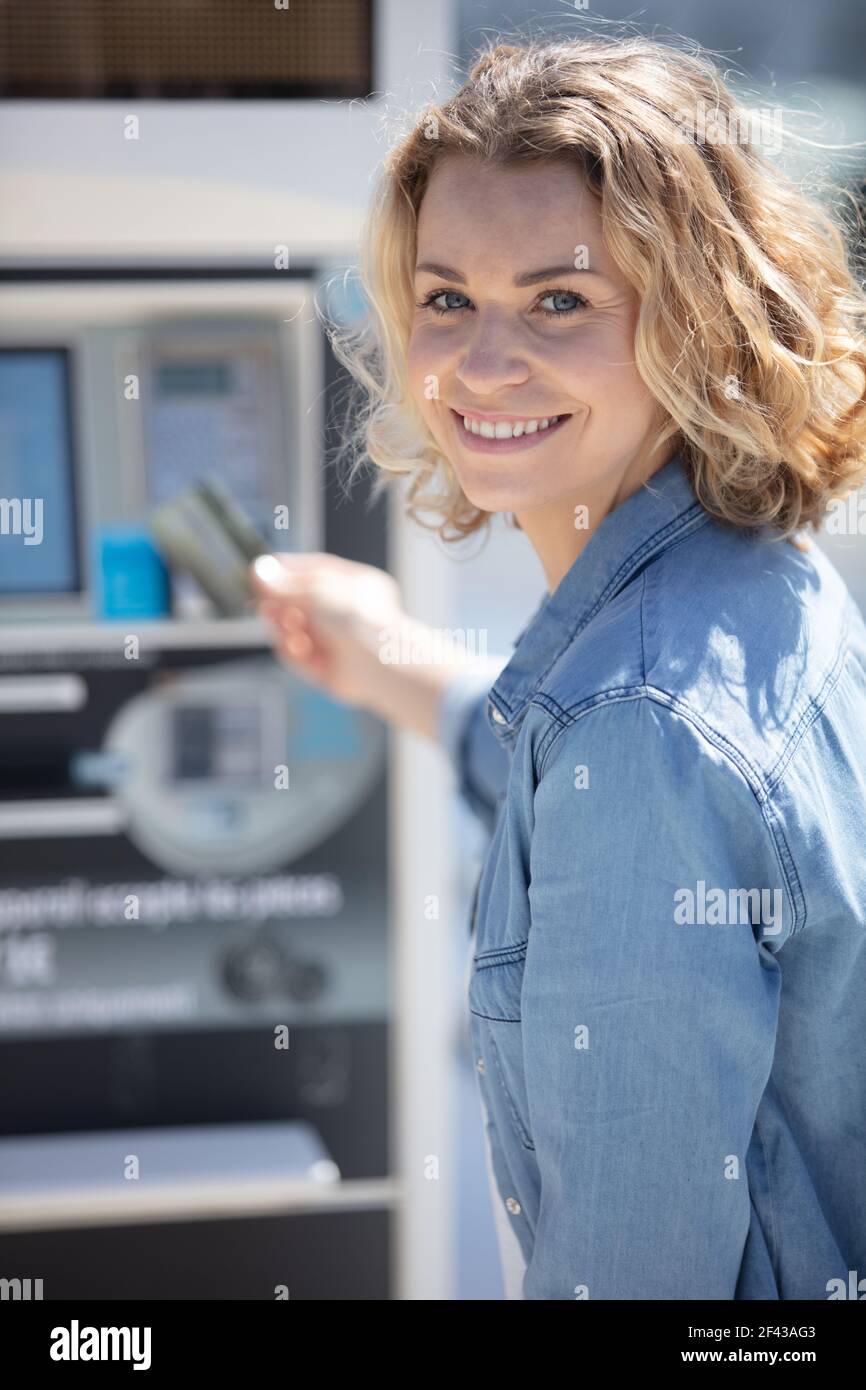 happy woman at the parking ticket machine Stock Photo - Alamy