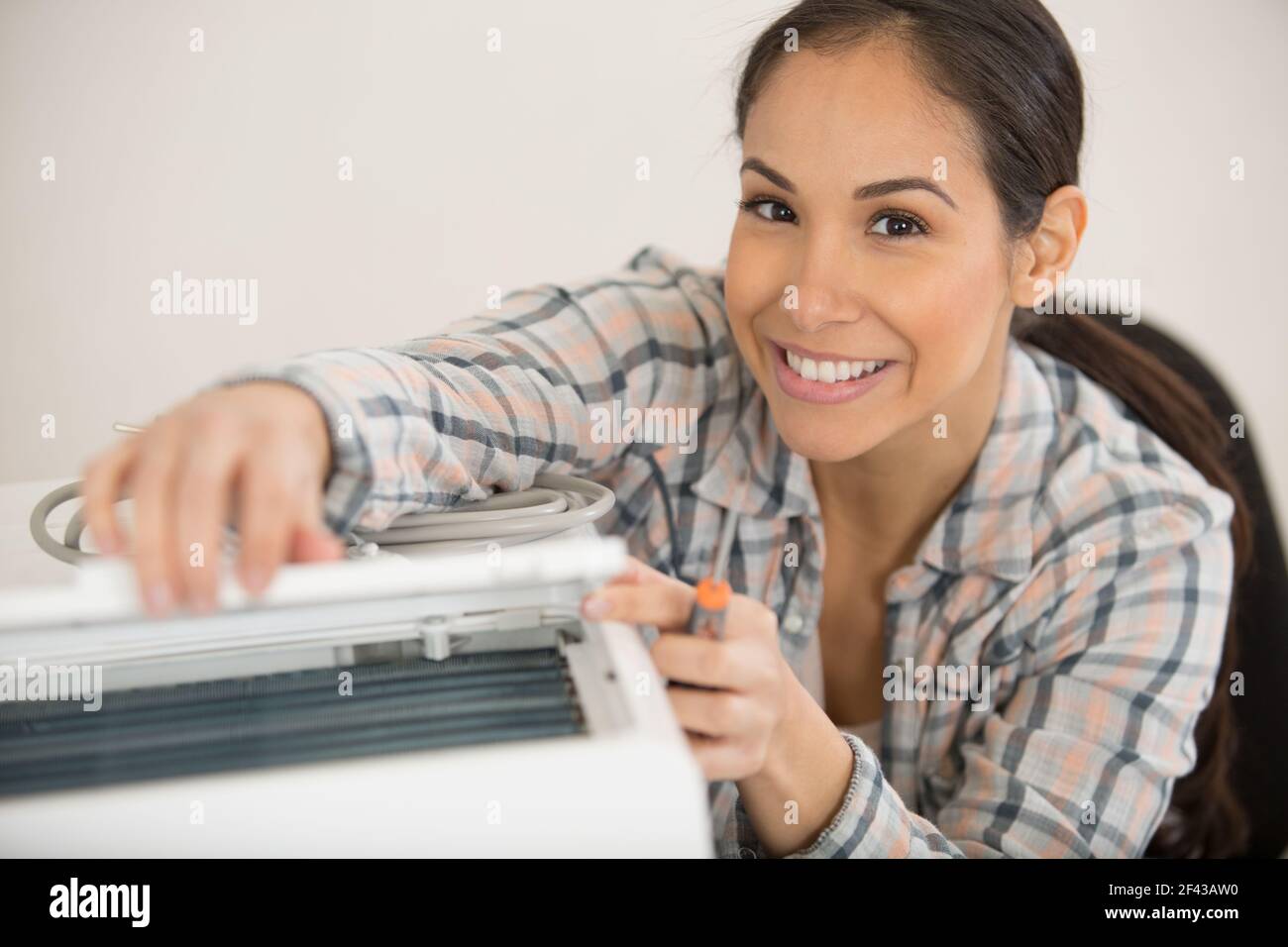 a woman is fixing a printer Stock Photo - Alamy