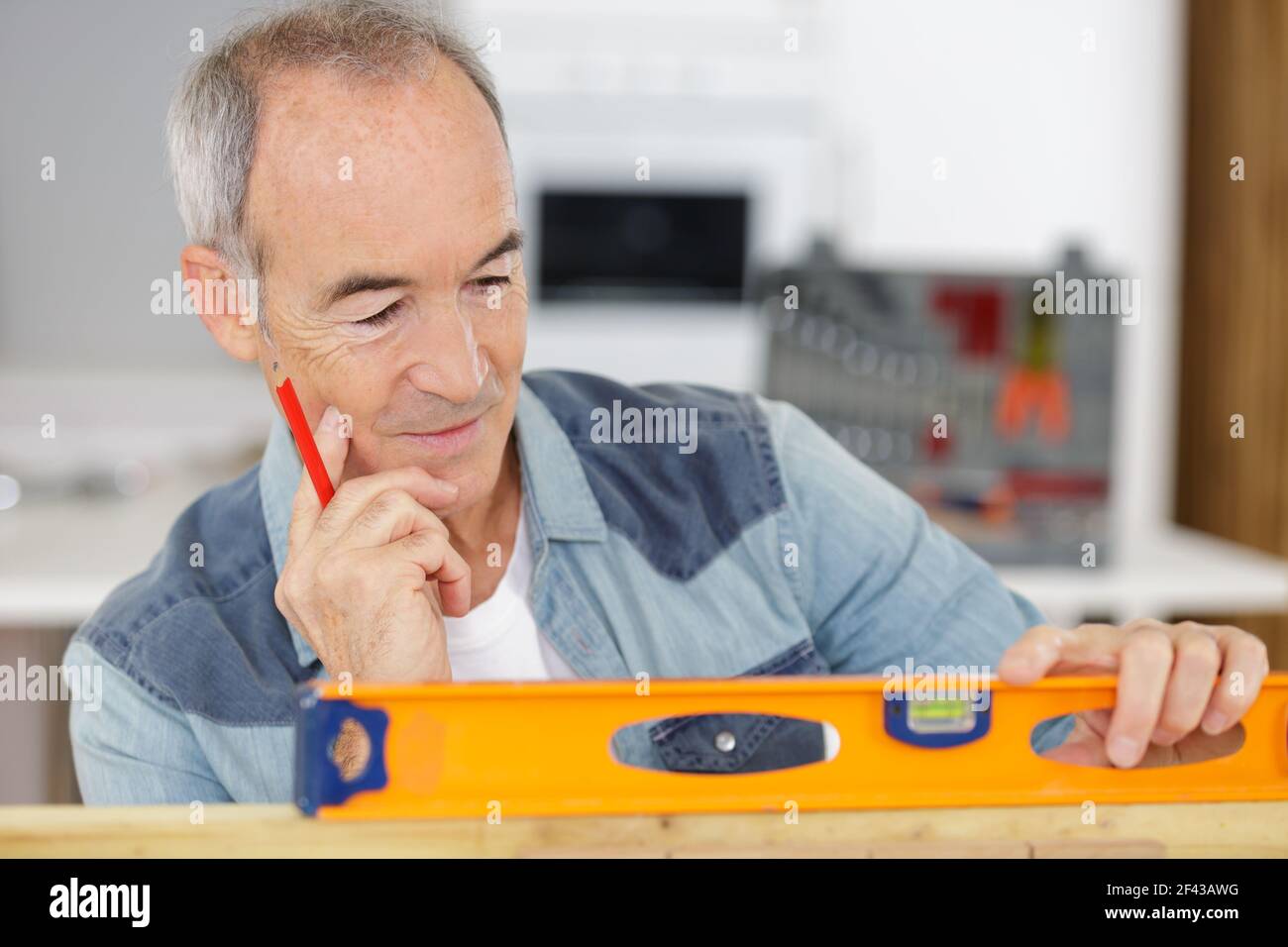 senior man using spirit level Stock Photo - Alamy