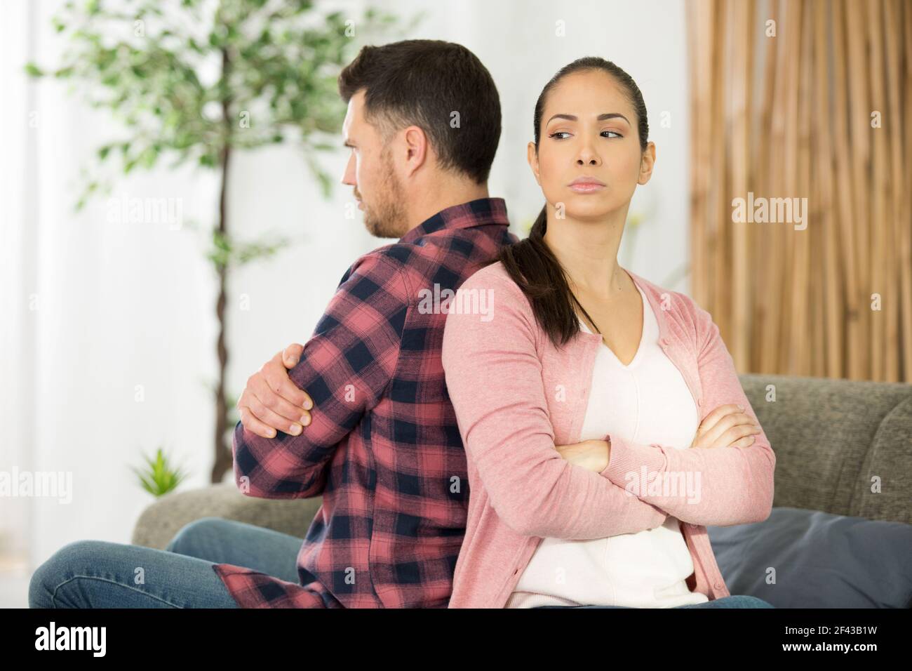 Unhappy couple on sofa sit hi-res stock photography and images - Alamy