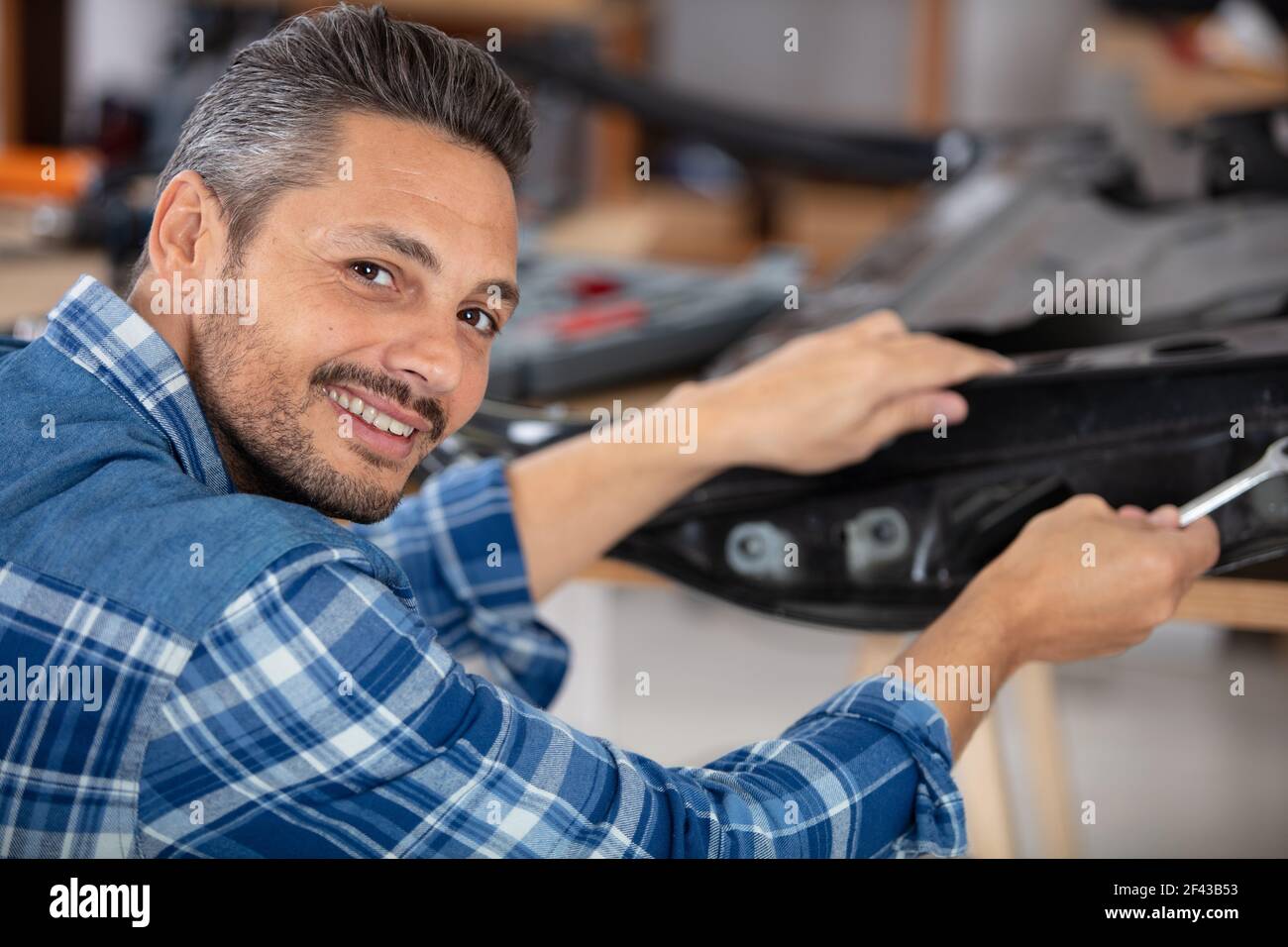 mechanic using spanner to repair car bodywork Stock Photo - Alamy