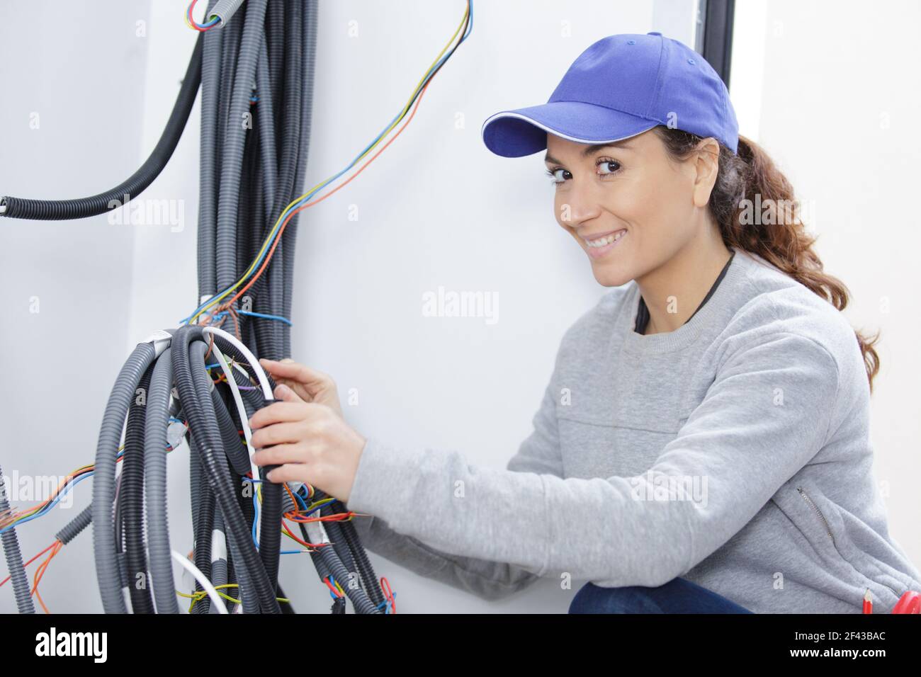 female electrician fixing electric cables in socket Stock Photo - Alamy