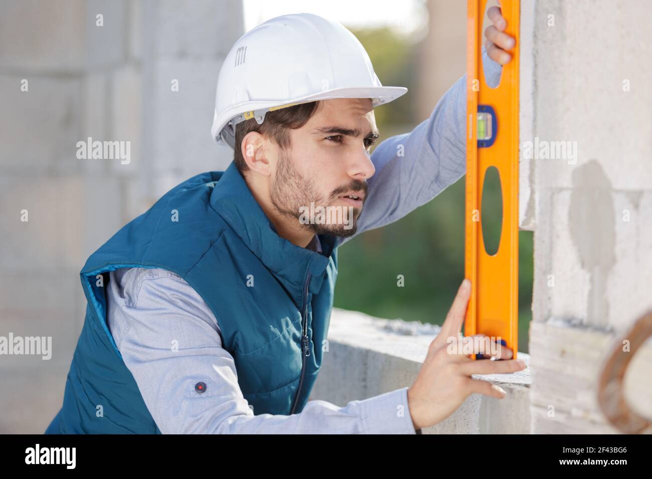 repairman measuring with the help of builder level Stock Photo - Alamy