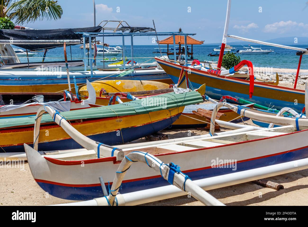 Traditional Indonesian outrigger style wooden fishing boat (jukung) on ...