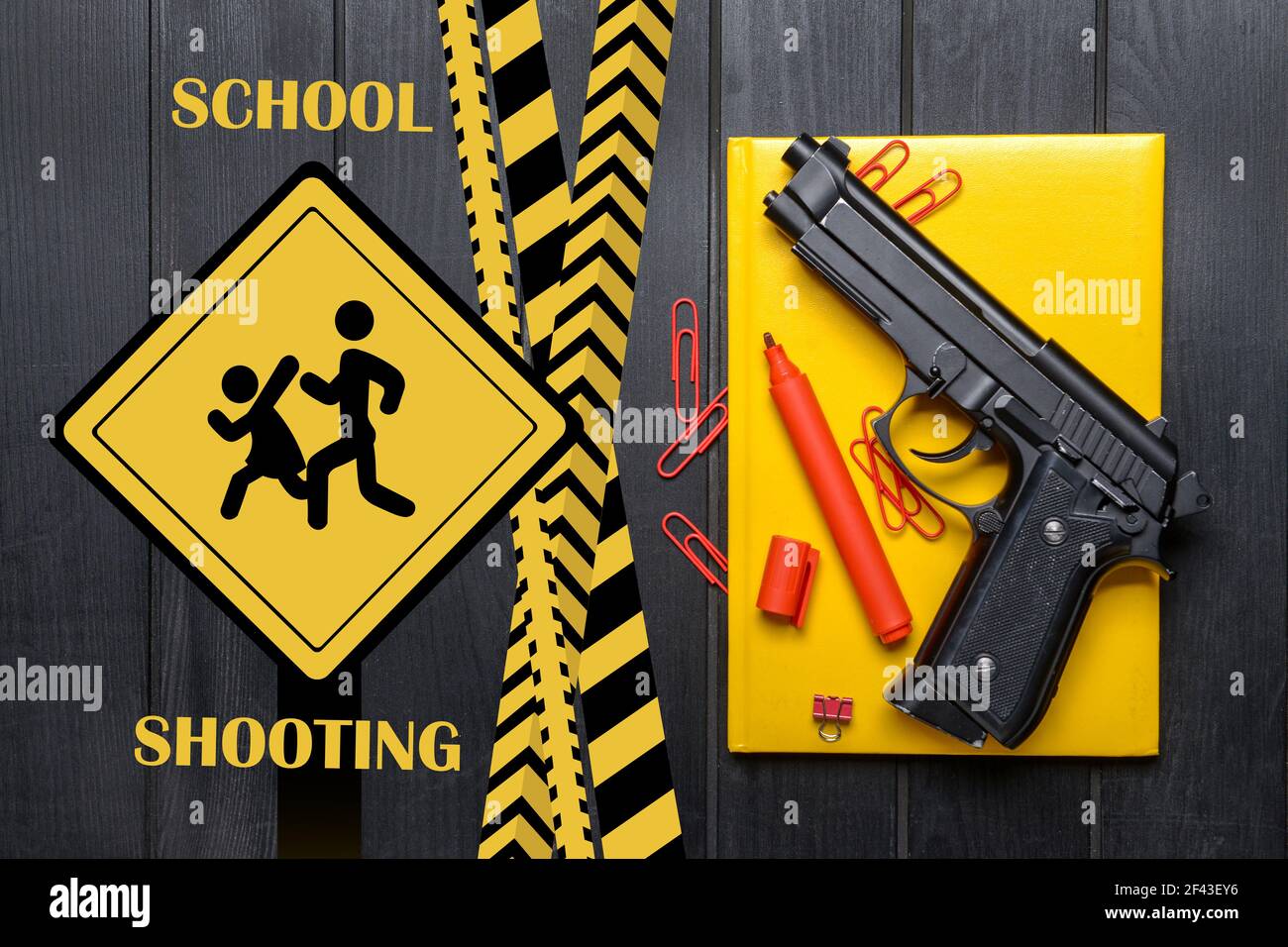 Gun and stationery on wooden background. Problem of shooting at school ...