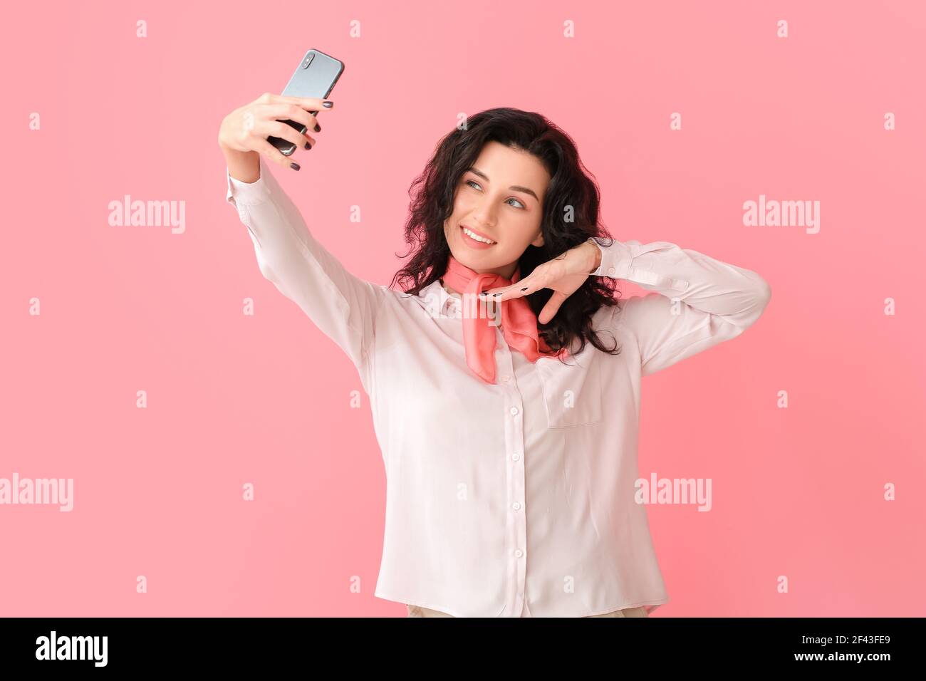 Beautiful young woman taking selfie on color background Stock Photo - Alamy