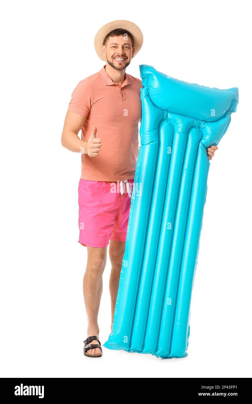 Handsome man with inflatable mattress on white background Stock Photo ...