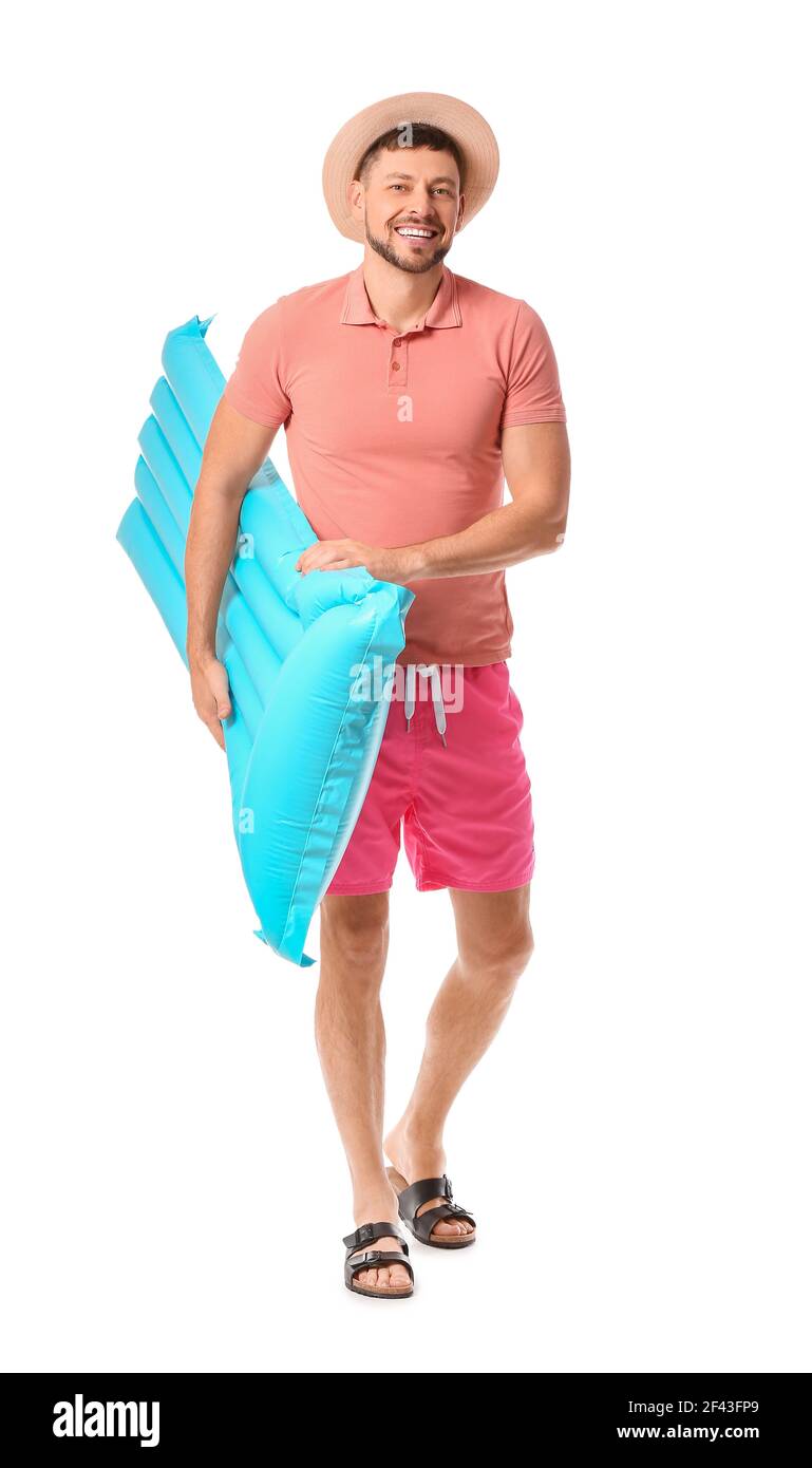 Handsome man with inflatable mattress on white background Stock Photo ...