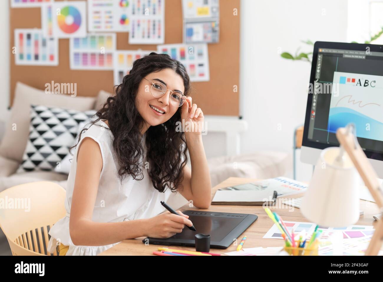 Graphic designer working in office Stock Photo - Alamy