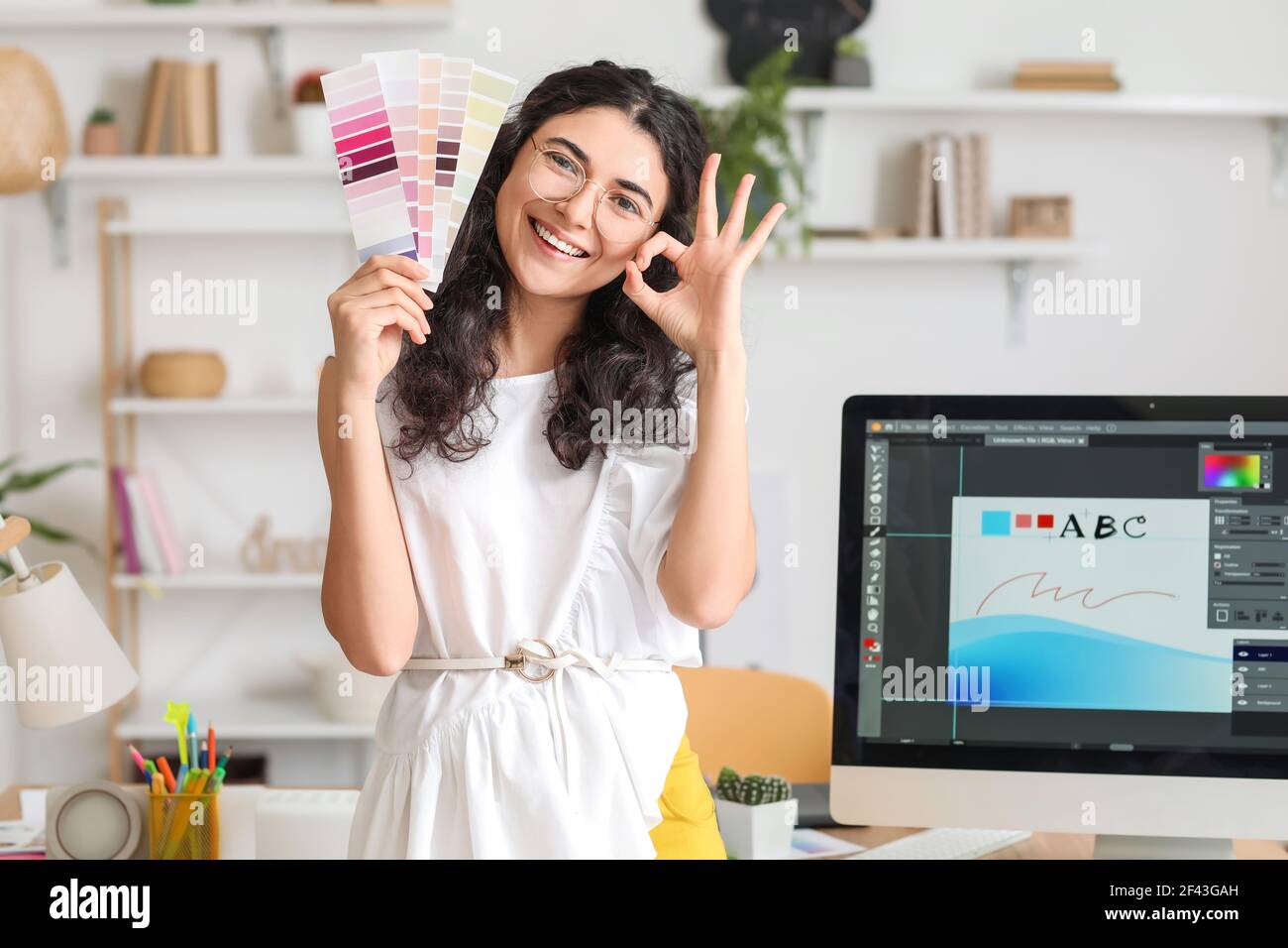 Graphic designer showing OK in office Stock Photo - Alamy