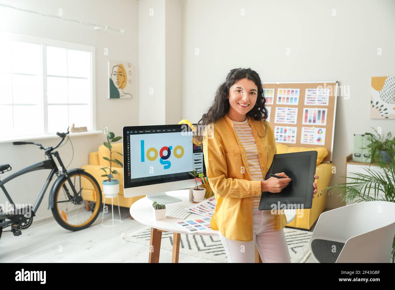 Graphic designer working in office Stock Photo - Alamy