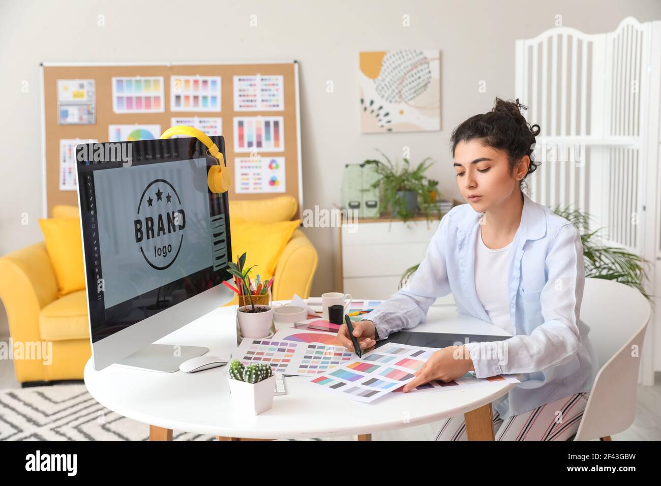 Graphic designer working in office Stock Photo - Alamy