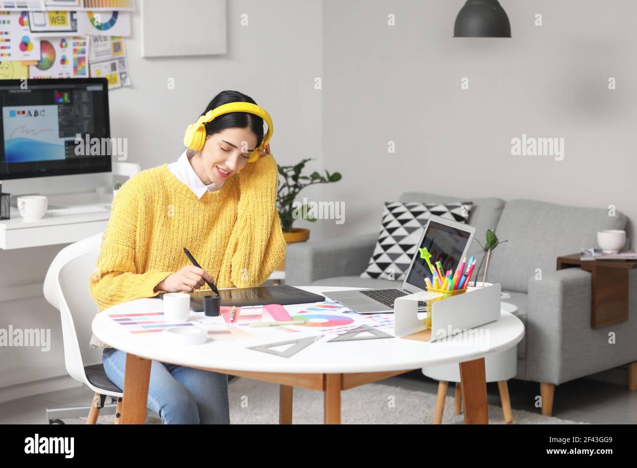 Graphic designer working in office Stock Photo - Alamy