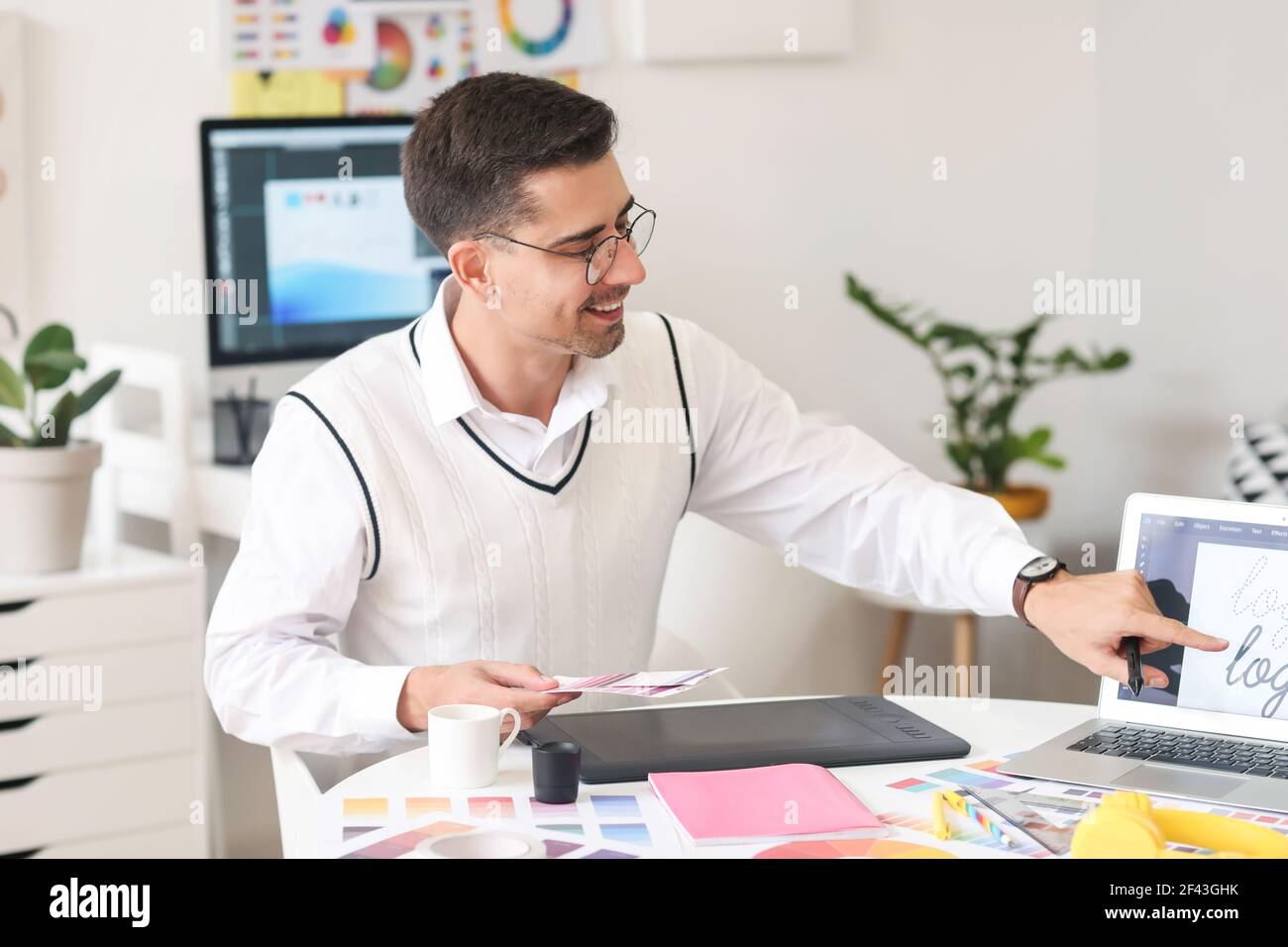 Graphic designer working in office Stock Photo - Alamy