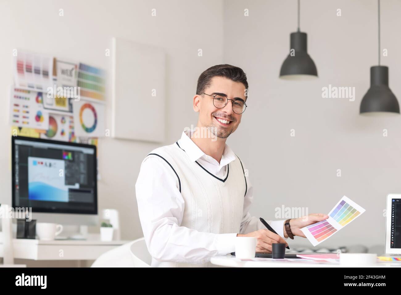 Graphic designer working in office Stock Photo - Alamy