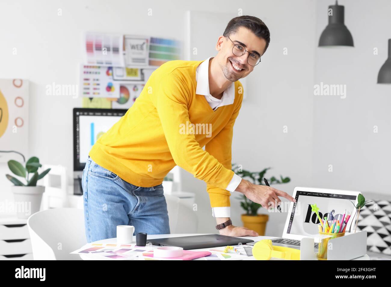 Graphic designer working in office Stock Photo - Alamy
