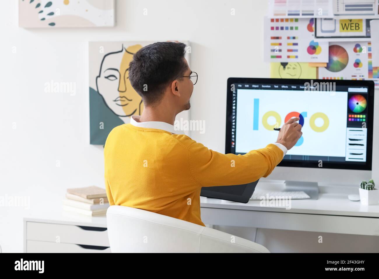 Graphic designer working in office Stock Photo - Alamy