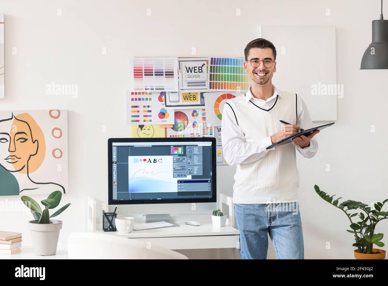 Graphic designer working in office Stock Photo - Alamy