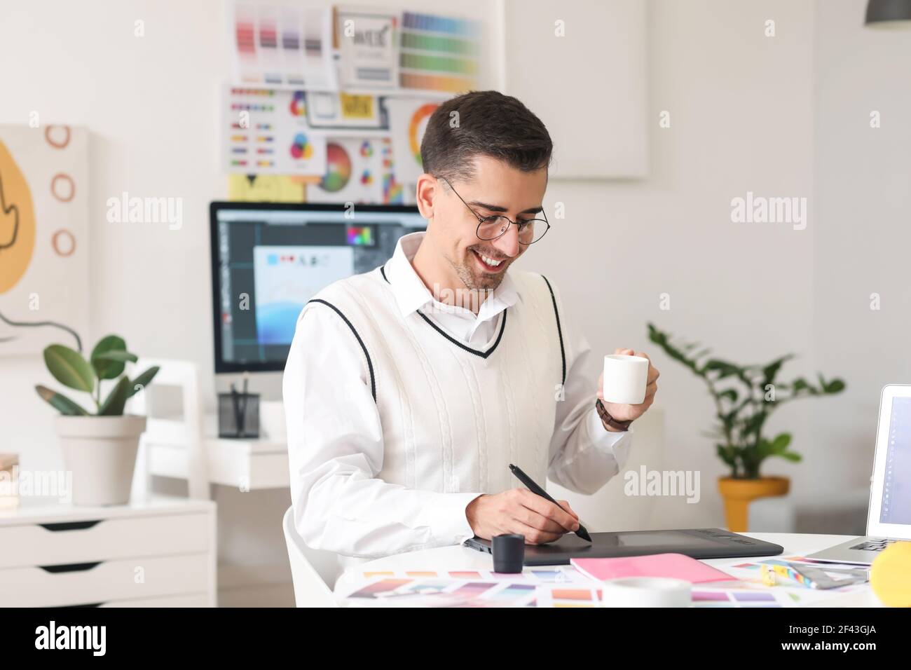 Graphic designer working in office Stock Photo - Alamy