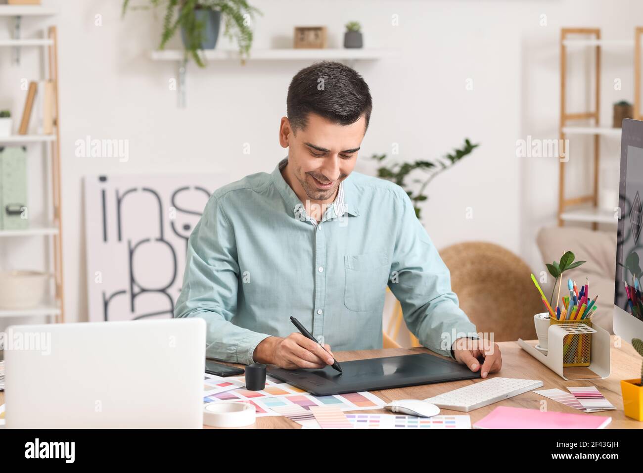 Graphic designer working in office Stock Photo - Alamy