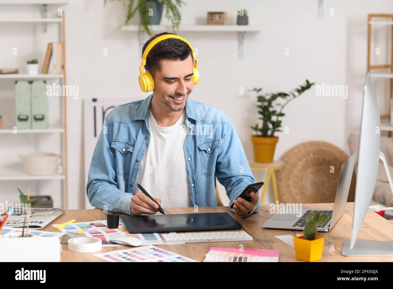 Graphic designer working in office Stock Photo - Alamy