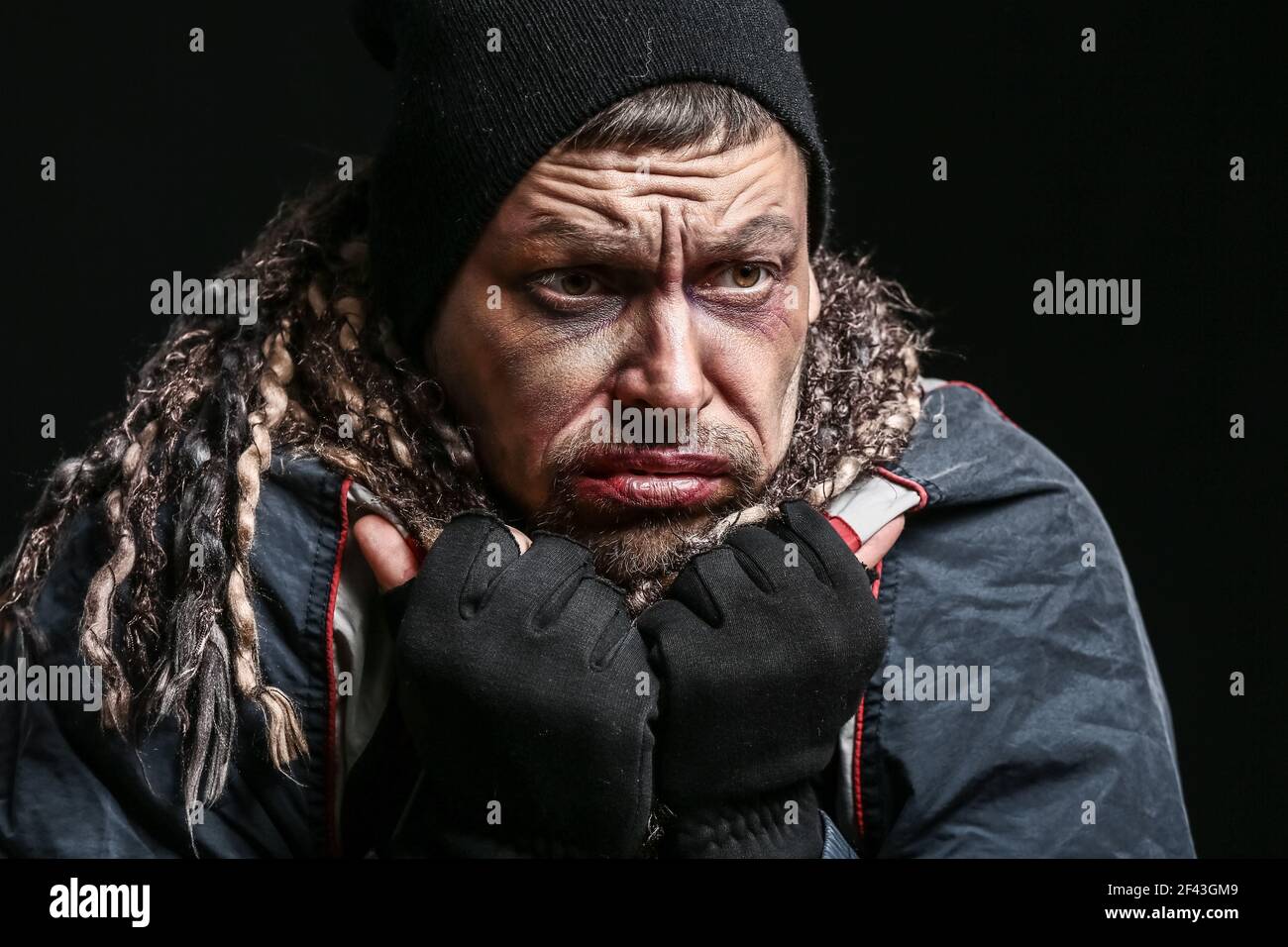 Portrait of poor homeless man on dark background Stock Photo - Alamy
