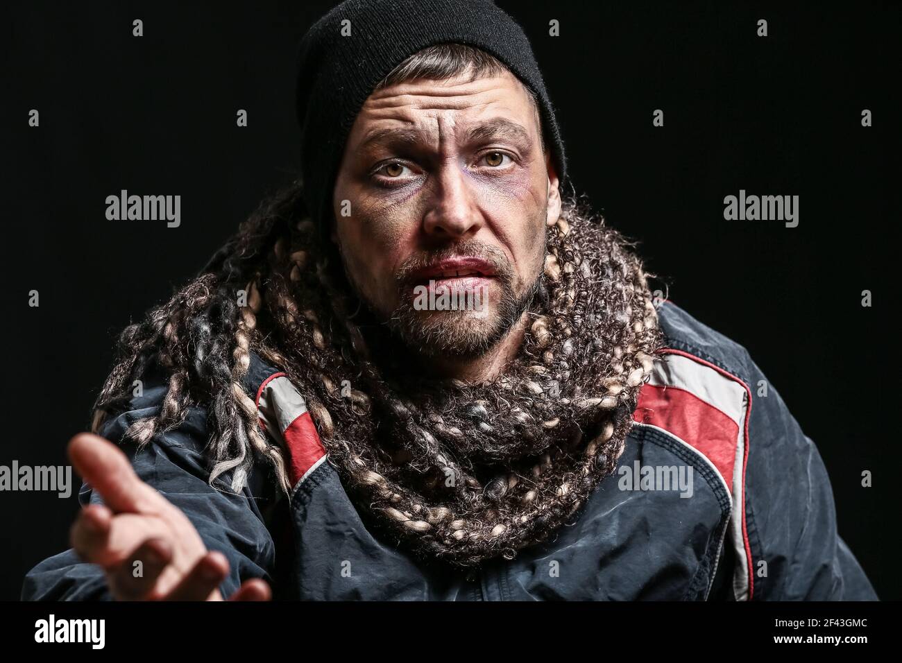 Portrait of poor homeless man on dark background Stock Photo - Alamy