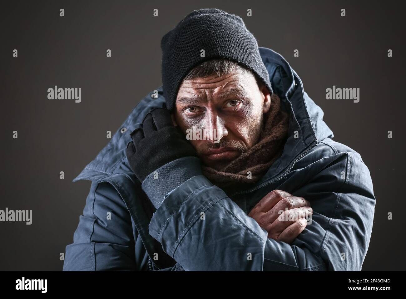 Portrait of poor homeless man on dark background Stock Photo - Alamy