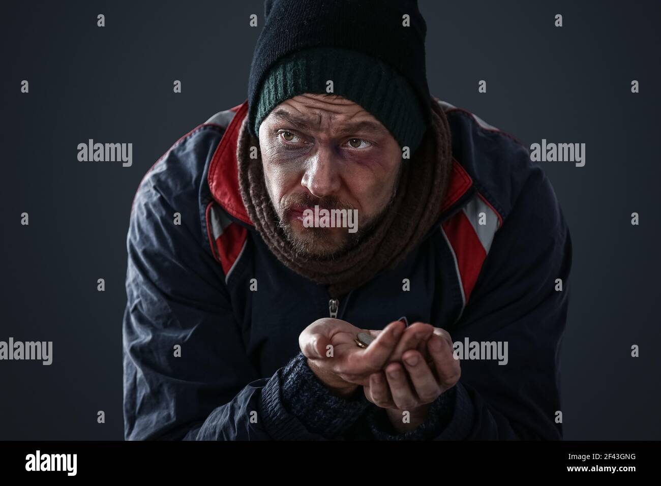Portrait of poor homeless man on dark background Stock Photo - Alamy
