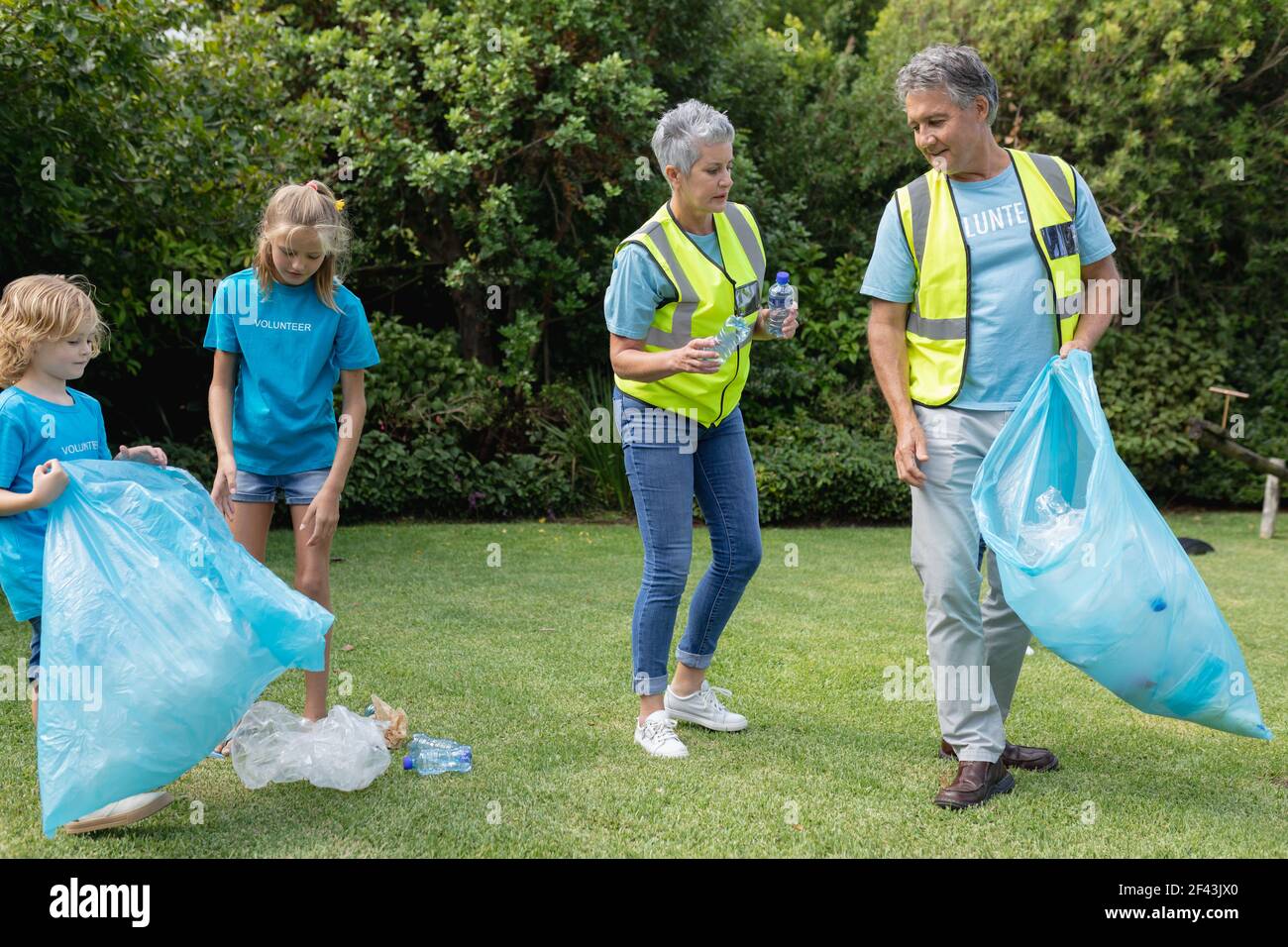 Caucasian multi generation group of men and women collecting rubbish in ...