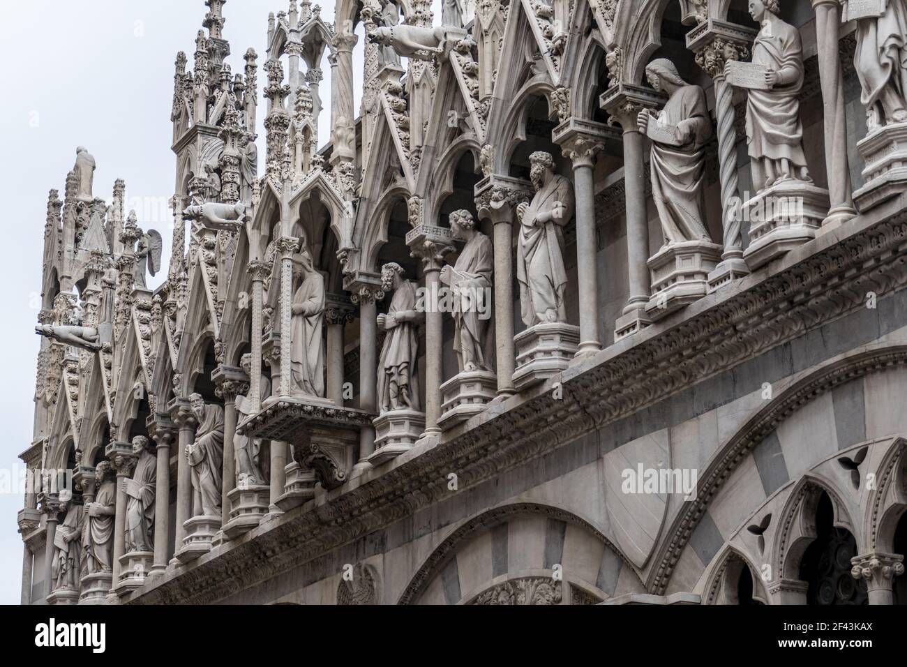 A side view of the Santa Maria Della Spina church wall with carvings ...