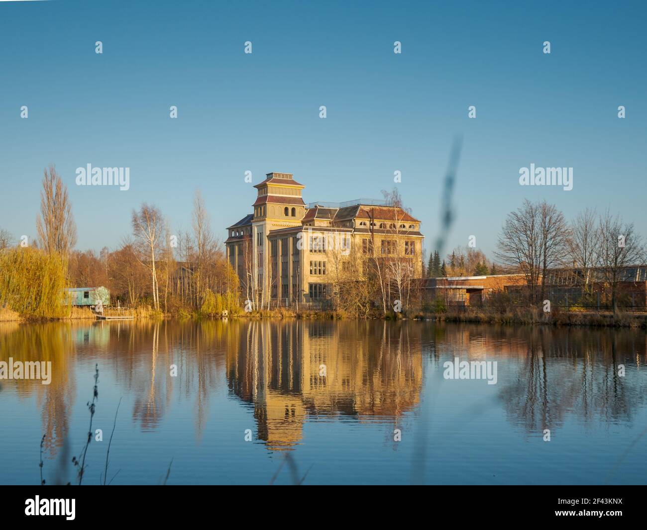 Old abandoned porcelain factory in evening sunset sunlight. Reflections ...