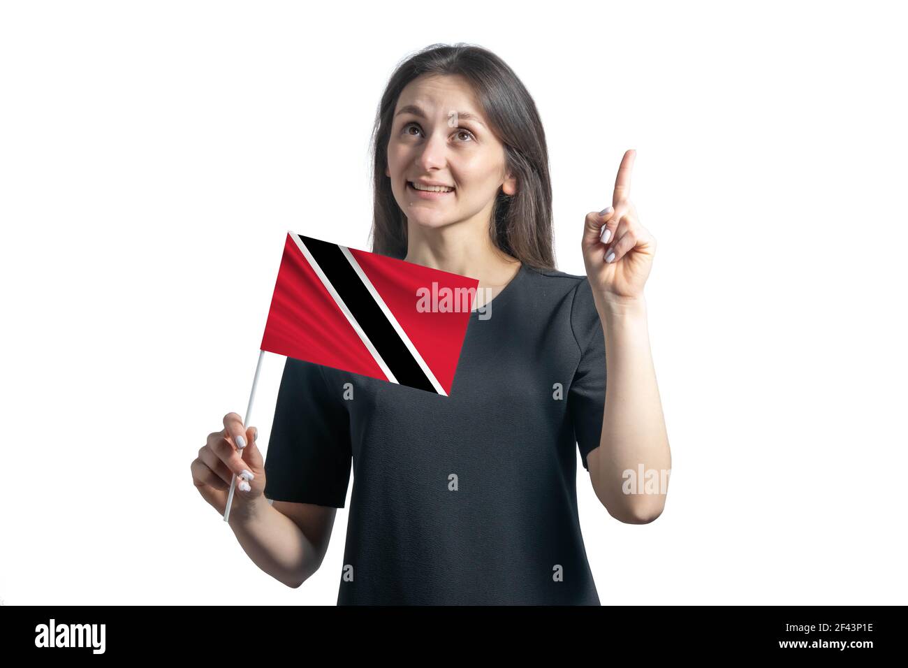 Happy young white woman holding flag of Trinidad and Tobago and points ...