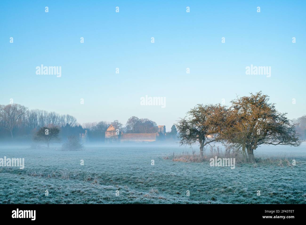 Minster Lovell Hall and village in the mist and frost at sunrise ...