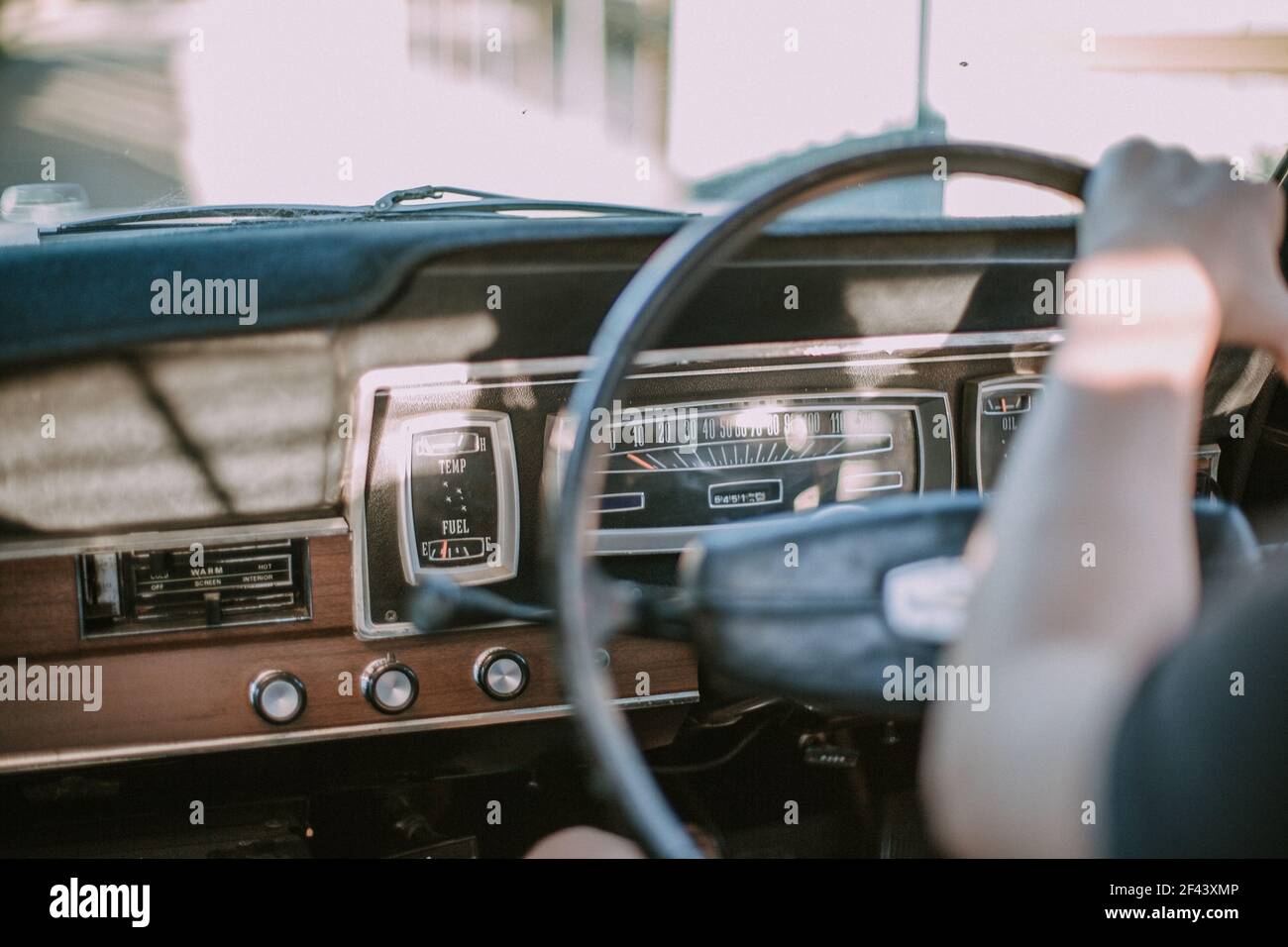 Driving ford valiant golden hour with arm across steering wheel classic ...
