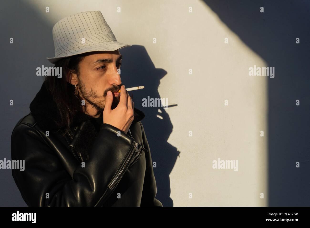 Young man smoking cigar outdoors hi-res stock photography and images ...