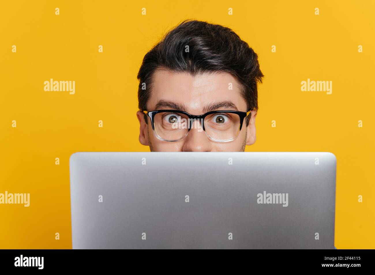 Excited young man looking laptop hi-res stock photography and images ...