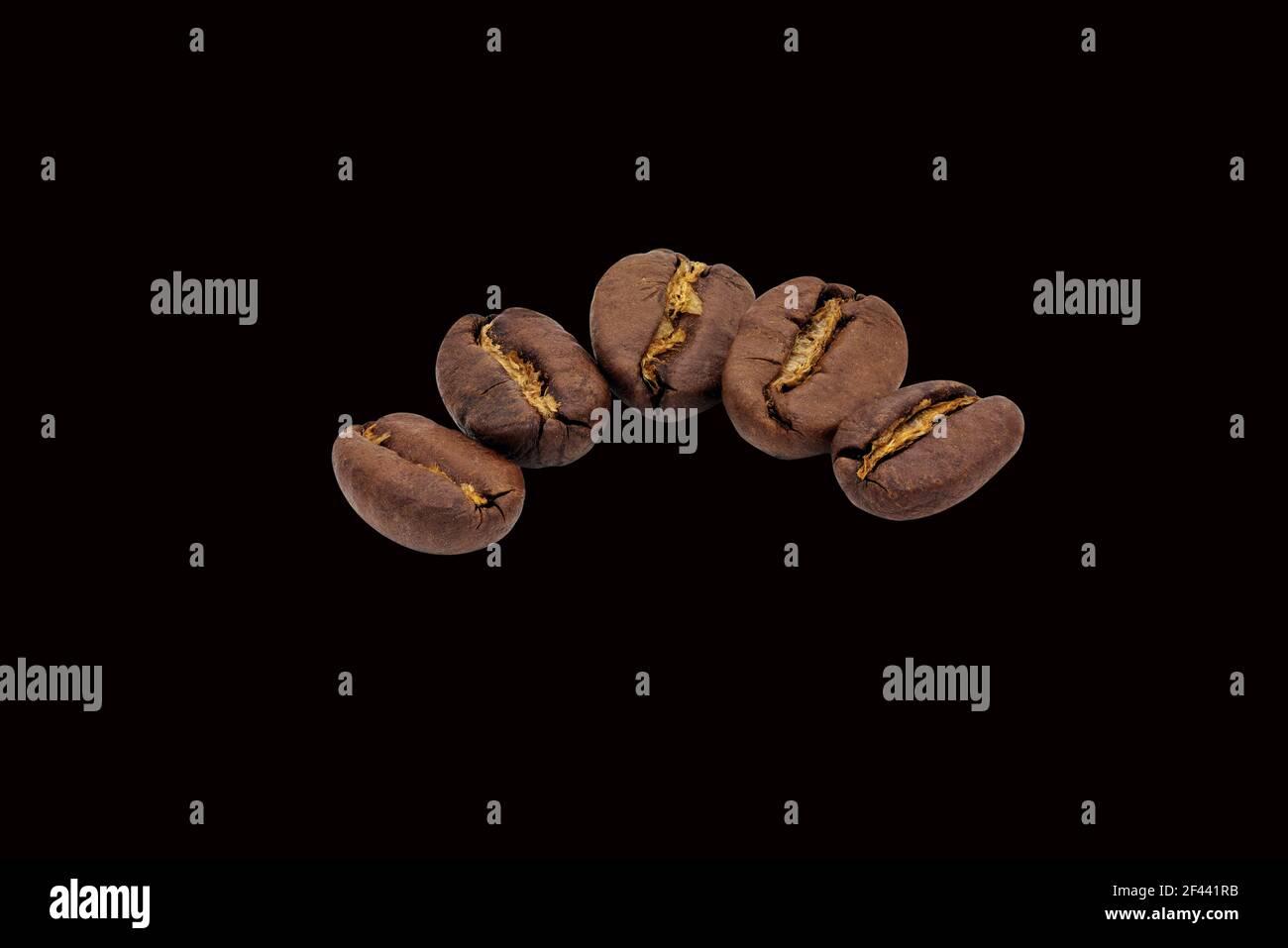 Roasted coffee beans, close-up. Coffee bean isolated on black. Five ...