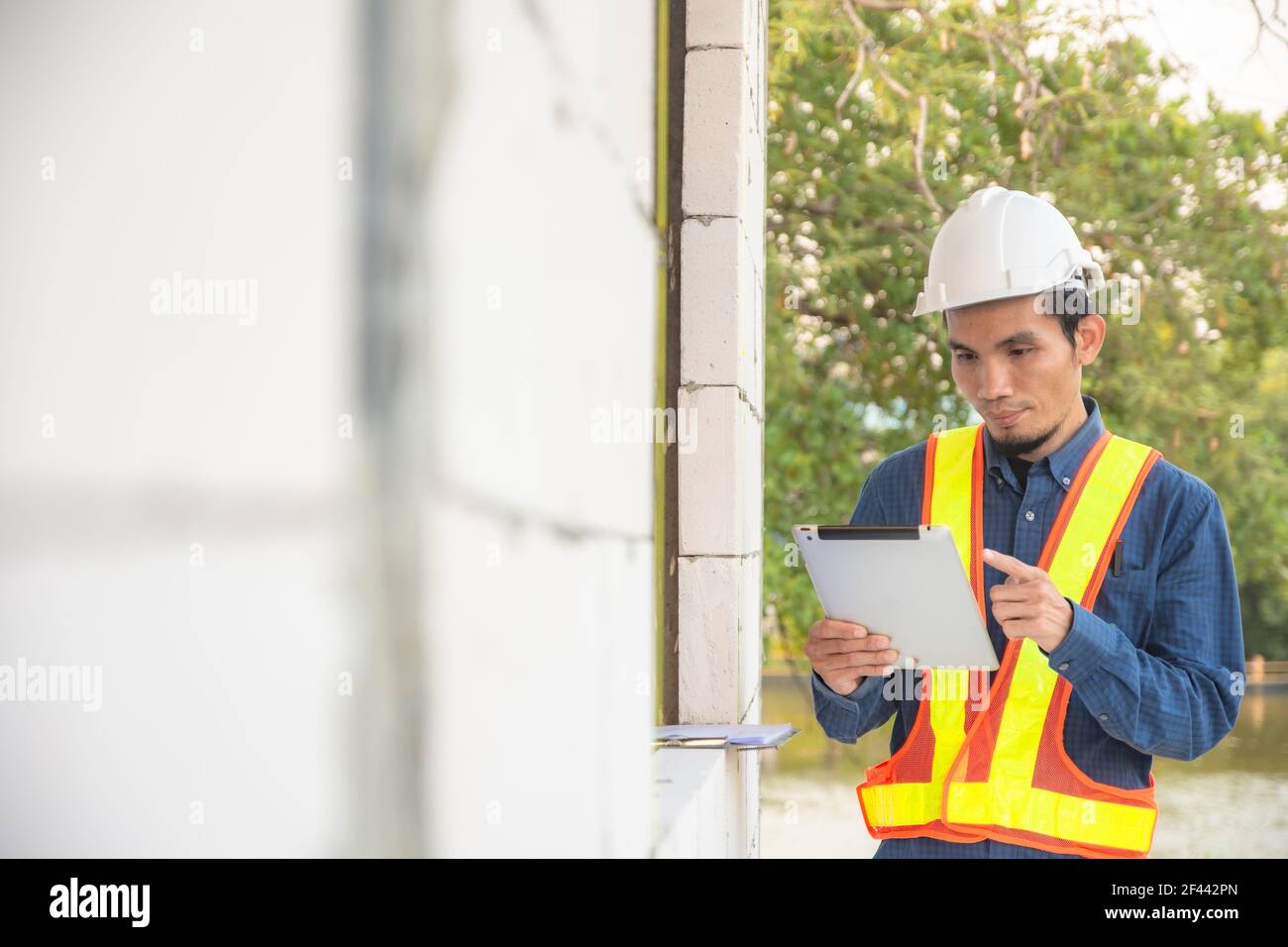 Foreman checking house in construction site by tablet technology Stock ...